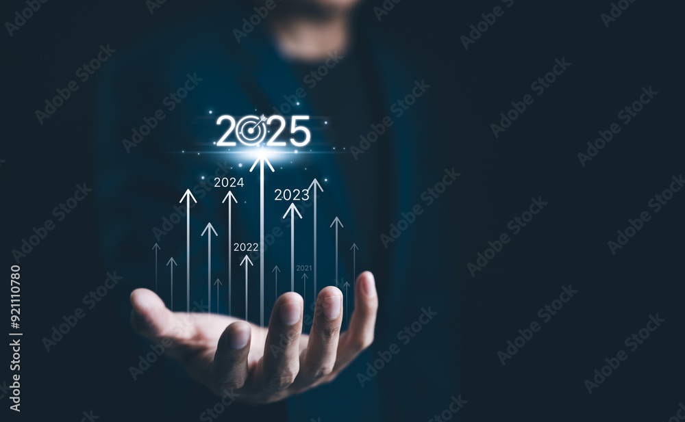 Businessman presents the year 2025 with ascending arrows representing ...