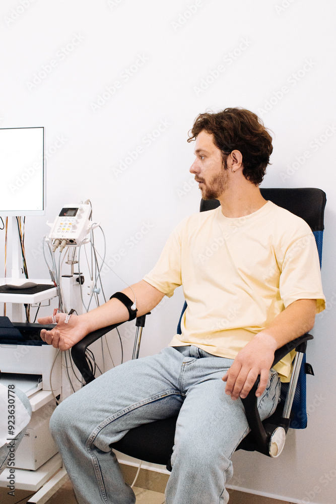 A patient undergoes nerve testing using electromyography (EMG). Perfect ...