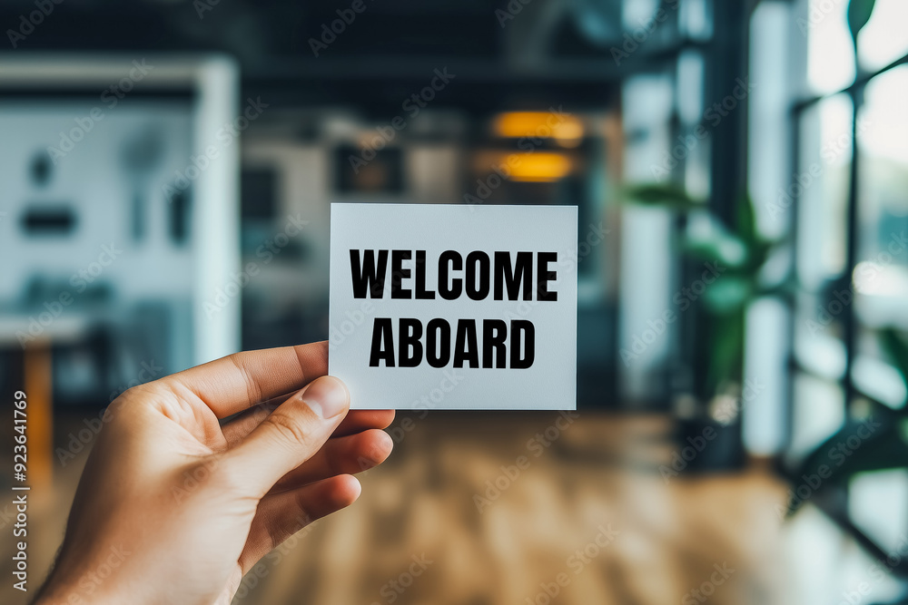 Welcome aboard message written on white paper with blurry office ...