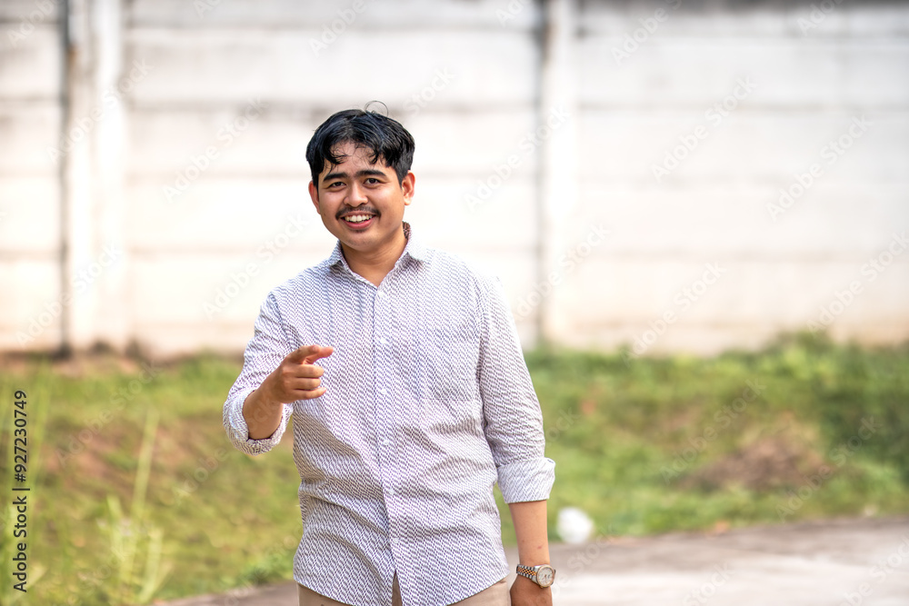 Smiling and pointing to front with finger poses. A guy smiling while ...