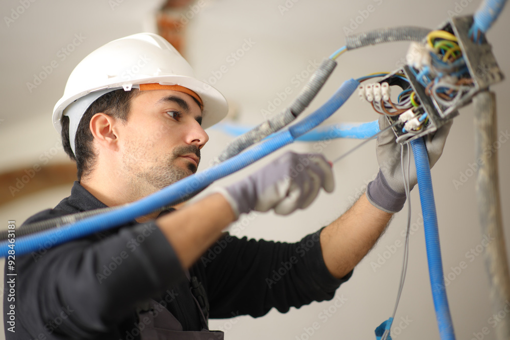 Electrician installing electrical system in a house under reform Stock ...