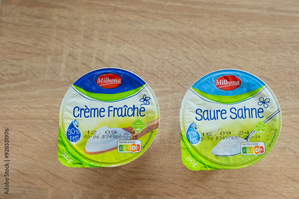 Milbona Creme Fraiche and Saure Sahne, common grocery store sight, containers dairy products ...