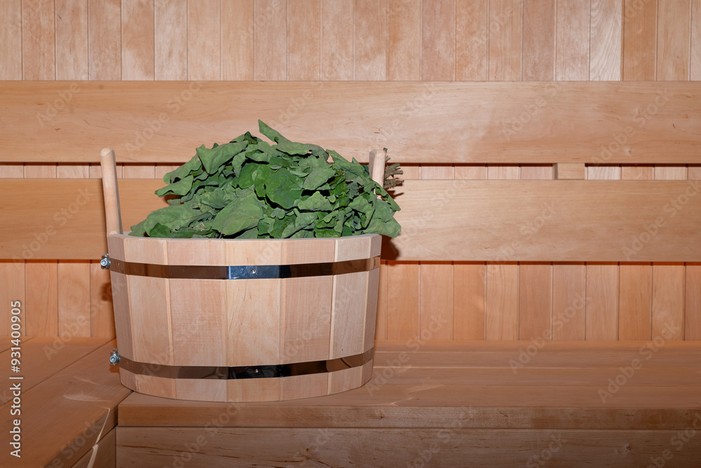 Wooden steam room in a sauna or banya with a bucket and an oak broom ...