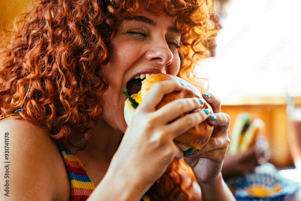Multiethnic group of friends having meal at 80s vintage diner ...
