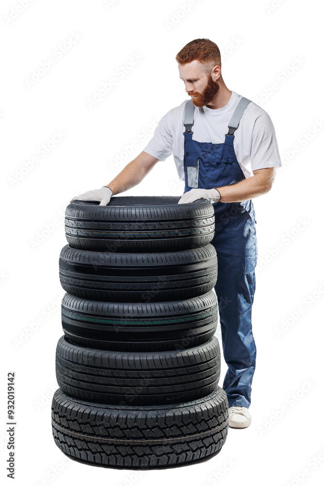 Smiling handsome car mechanic with new tire on white isolated ...