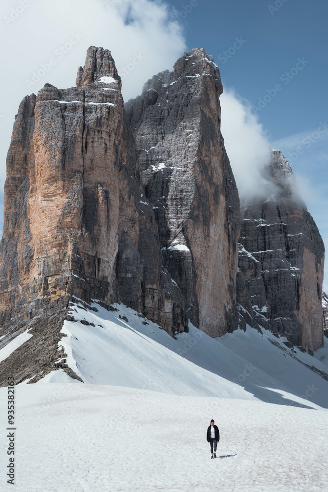 Girl standing in fronnt of a huge mountain in the Italian Alps, The ...