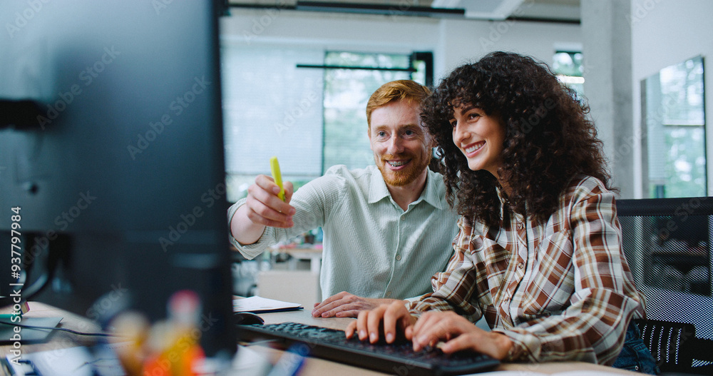 Caucasian female with curly hair working hard in modern office. Typing ...
