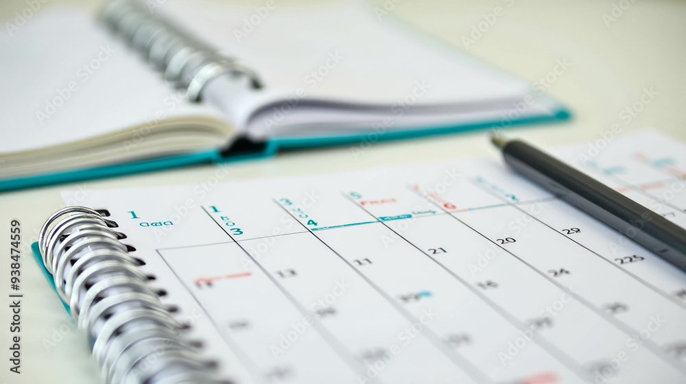An organized desk features a calendar planner displaying important ...