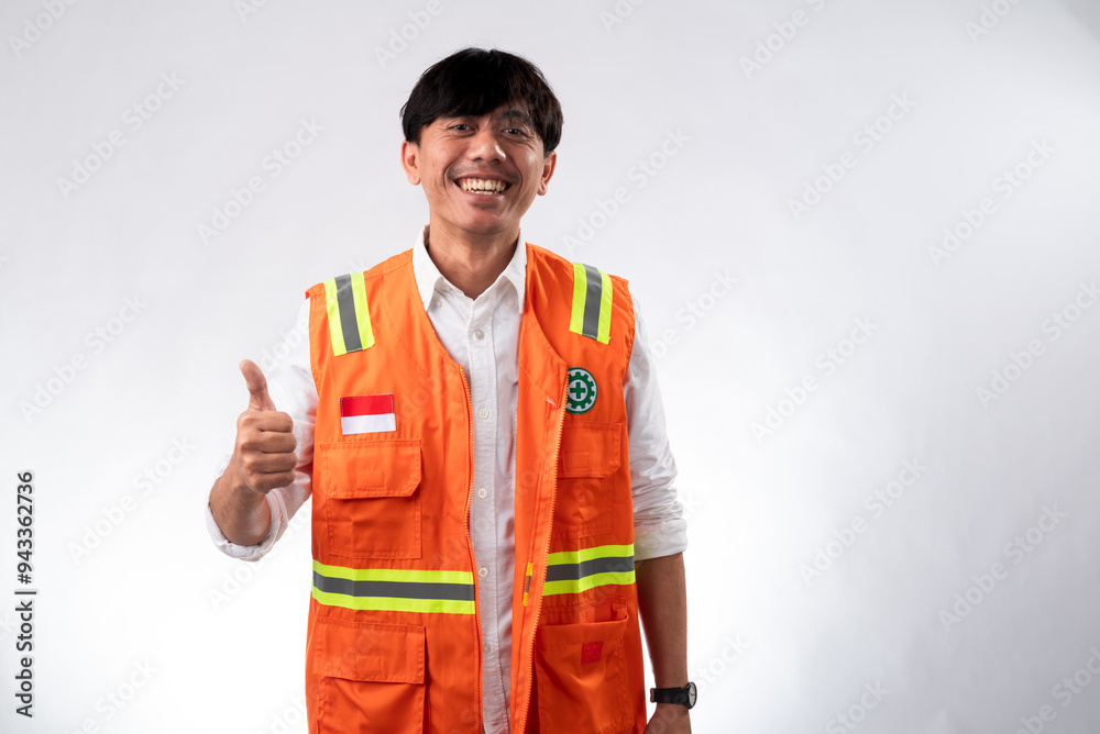 An Asian man, dressed in an orange safety vest with reflective stripes ...
