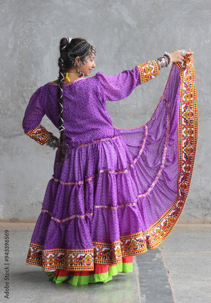 woman is wearing ruffled shrug of purple bandhani print. full flare ...