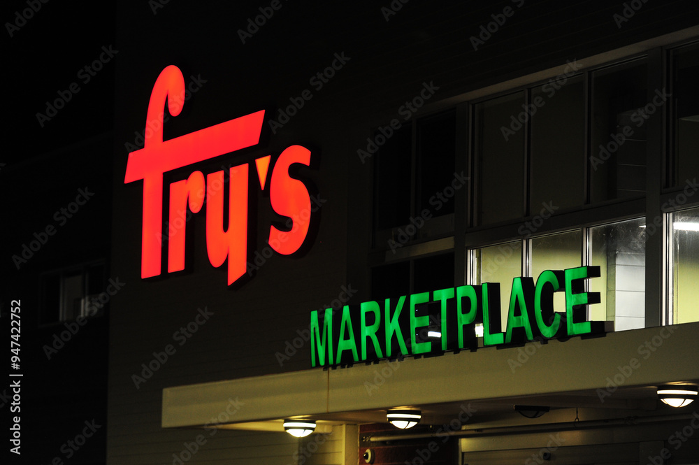 Fry's Marketplace storefront at night with a red Fry's electrical sign ...