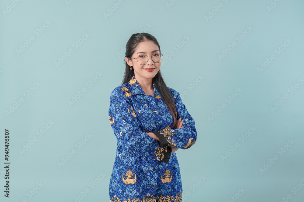 Confident government worker woman wearing blue batik uniform smiling ...