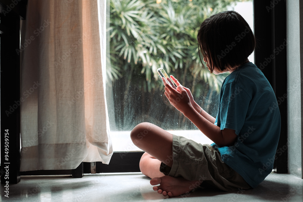 Stock-Foto „Depressed Asian child girl sitting near the window with ...