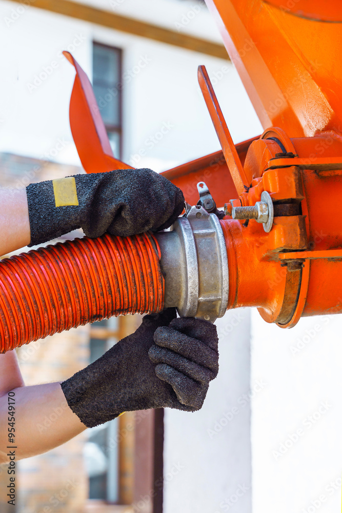 hand connects a suction hose to a sewage tanker truck. Sewer pumping ...