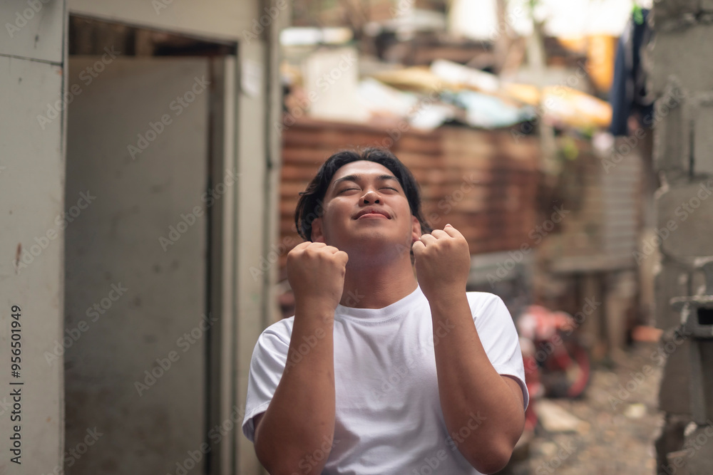 An elated young man looking up feeling overjoyed. Eyes closed feeling ...