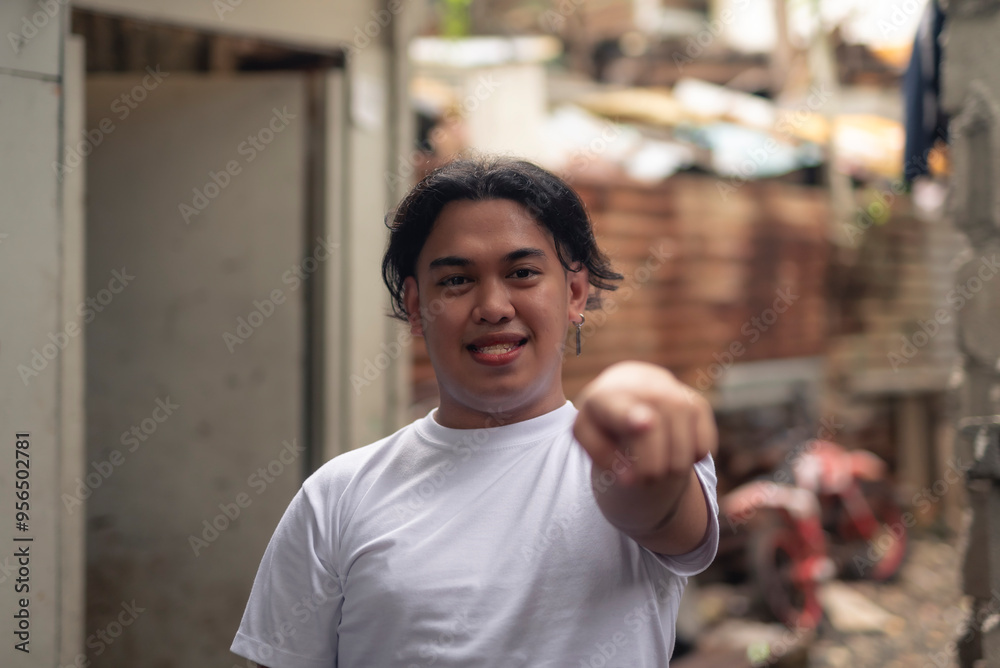 A young Filipino man pointing at the camera. A local person living in ...