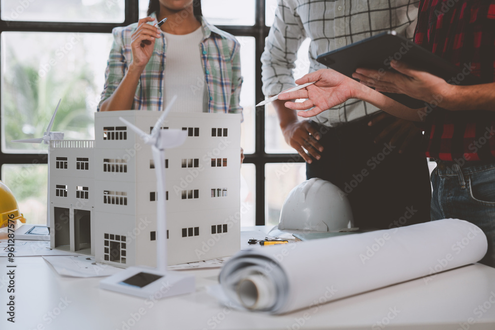 Structural engineering team discusses and calculates draft blueprint ...