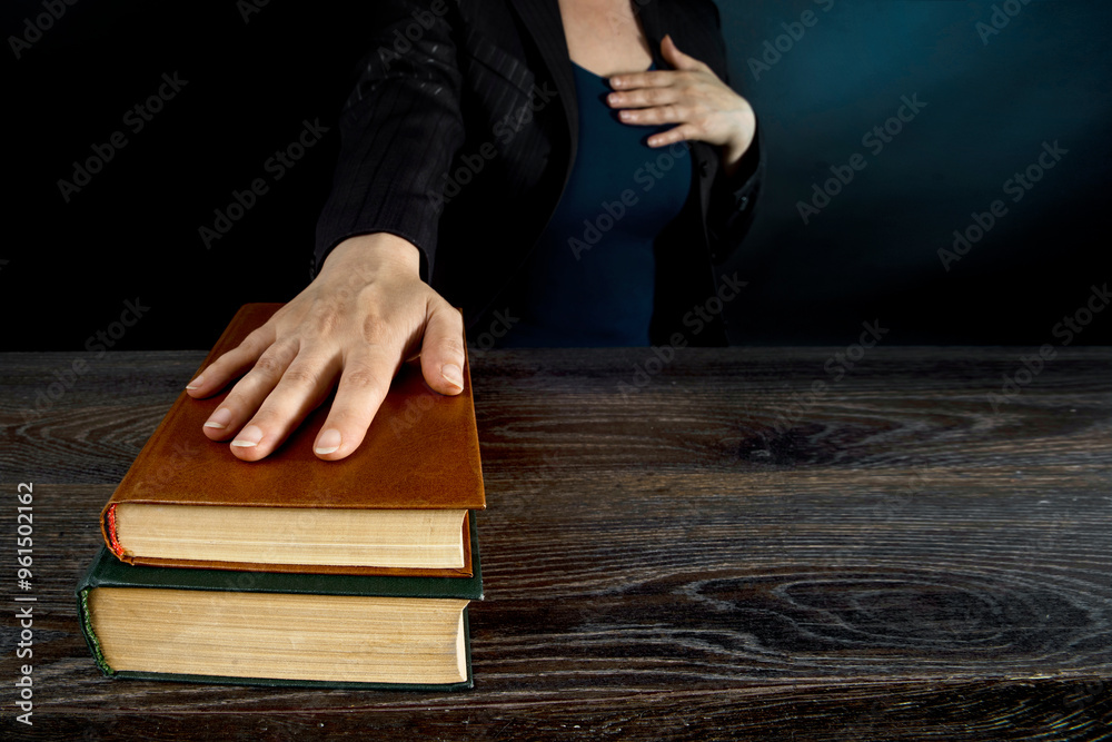 Female hand on the Bible and on the constitution book during the ...