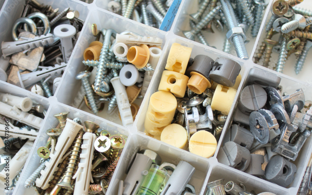 Screws, bolts, washers and ribbed anchors in a carpentry workshop ...