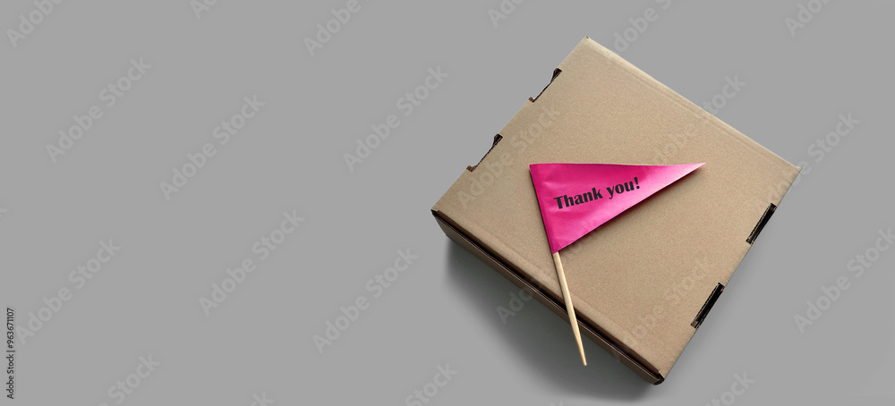 'Thank you' note day. Closed square cardboard box with tiny pink paper ...