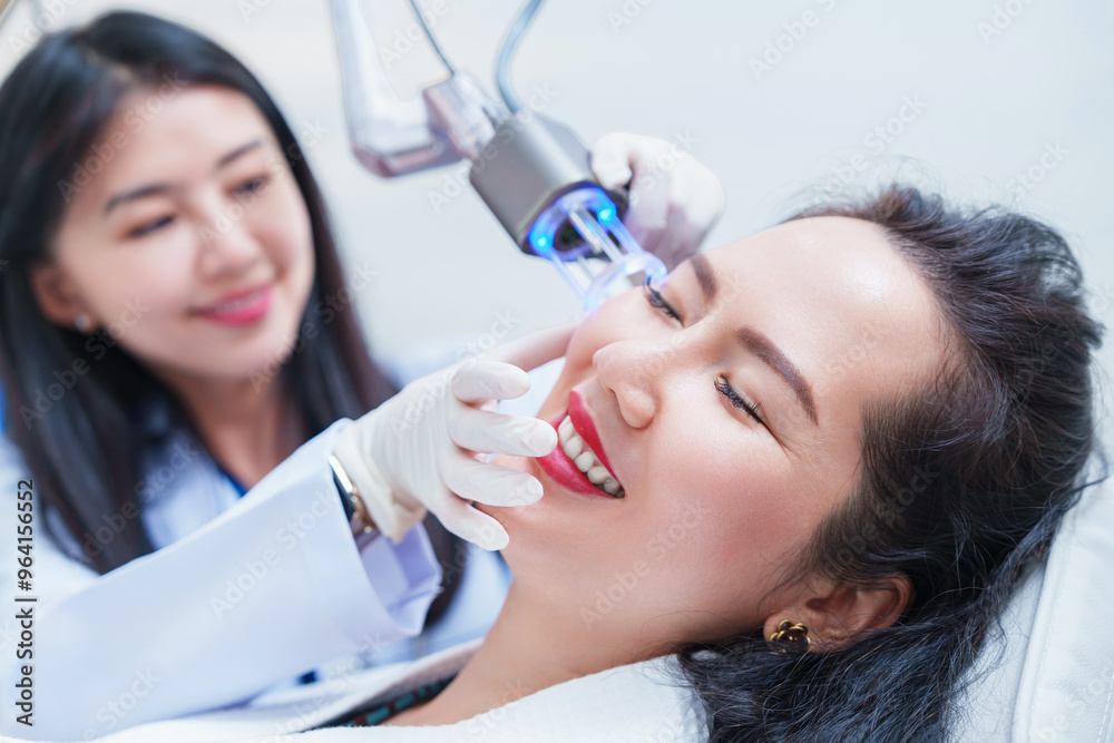 Side view of asian woman getting resurfacing laser fraxel dual and ...