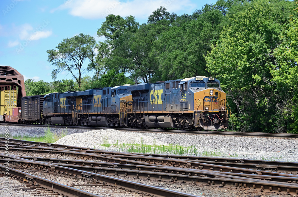 Three CSX Transportation locomotives lead an intermodal freight train ...
