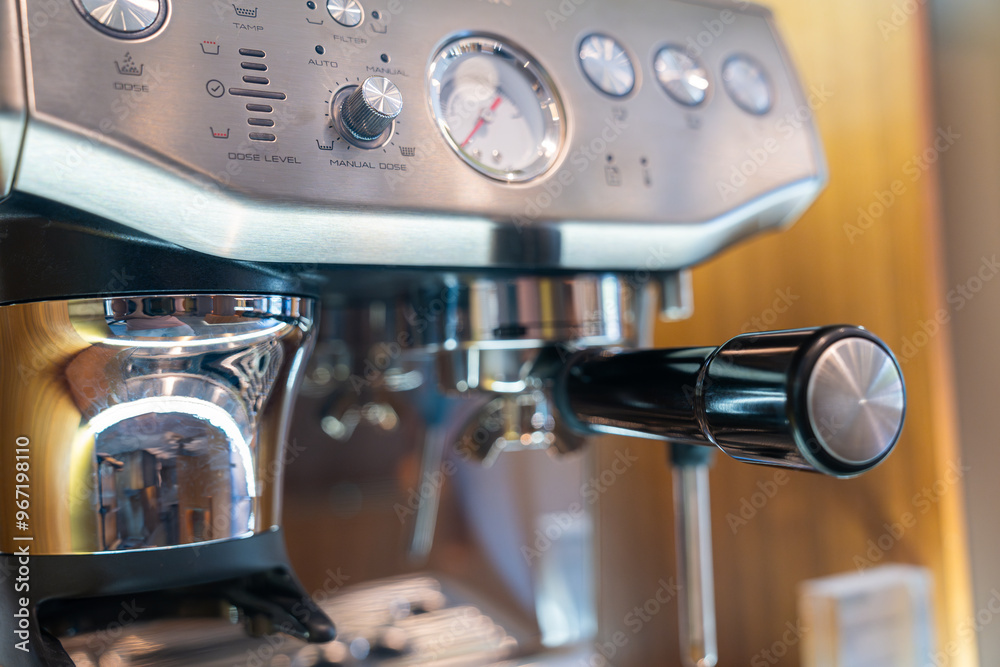Detailed close-up of a modern espresso machine handle, highlighting its ...