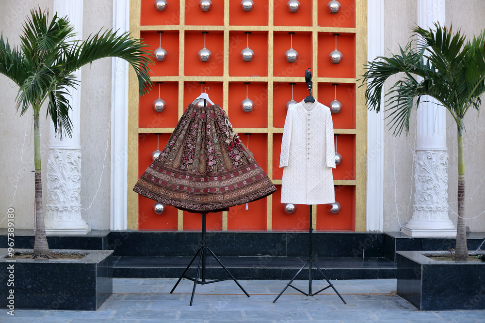 The image features a decorative display with traditional wedding attire ...