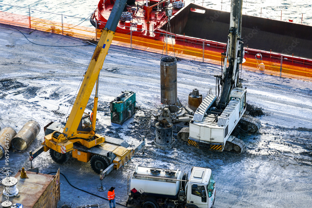 Installation of pile casings in the port quay, drilling rig, port ...