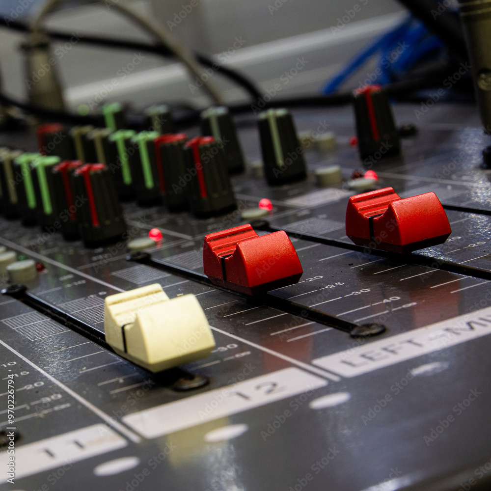 Professional analog audio mixing console with knobs and slides for ...