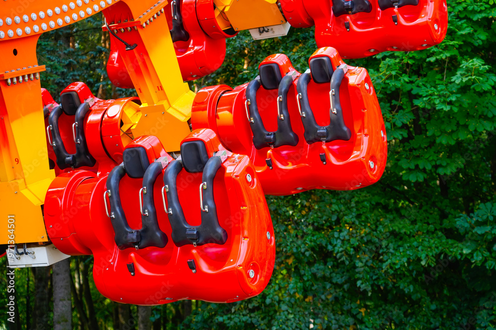 Empty red seats, extreme amusement park attraction rotation in a circle ...
