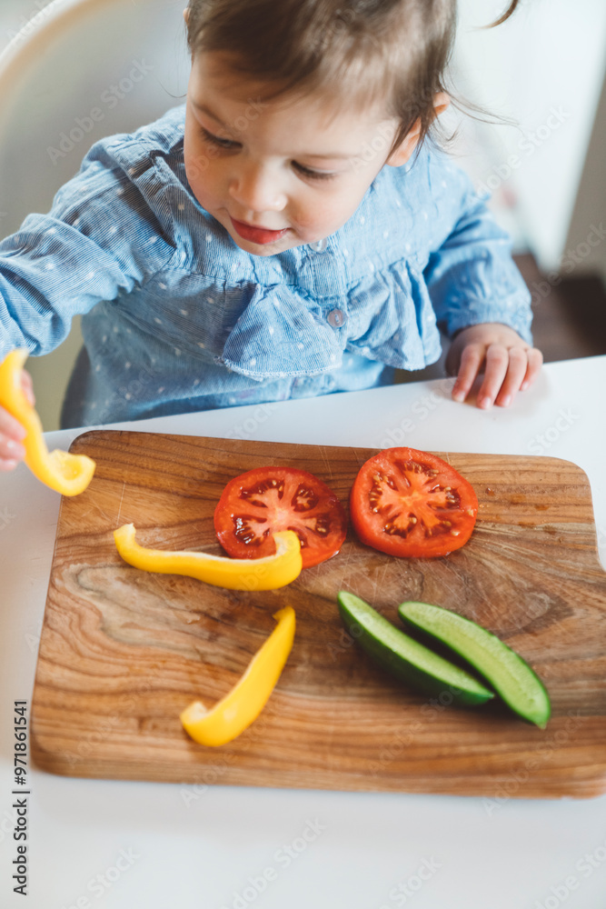 The baby is trying a new taste of solid food. Eating healthy food from ...
