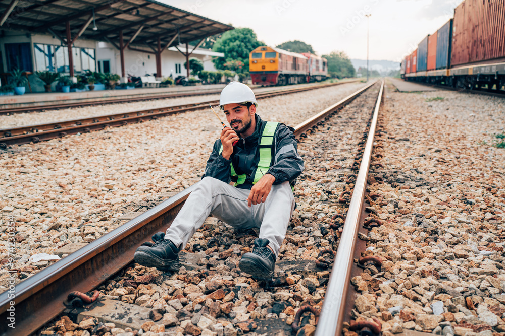 Engineer wearing safety uniform sitting on railway inspection ...