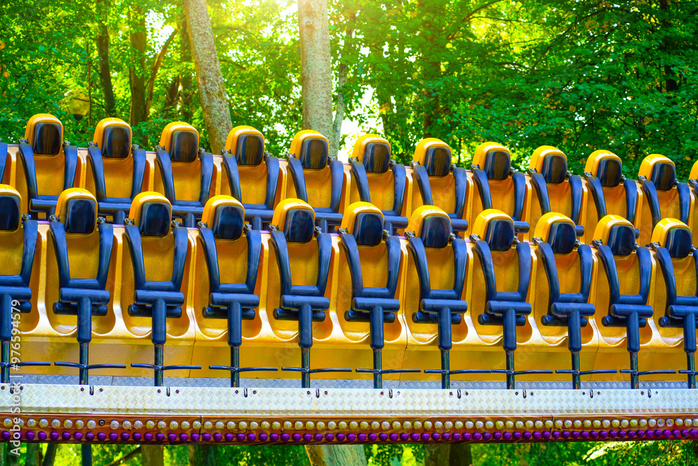 Empty yellow row seats, extreme amusement park attraction rotation in a ...