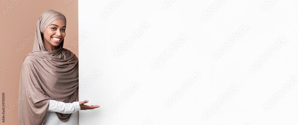 Look here. Smiling black muslim girl in hijab pointing at white ...