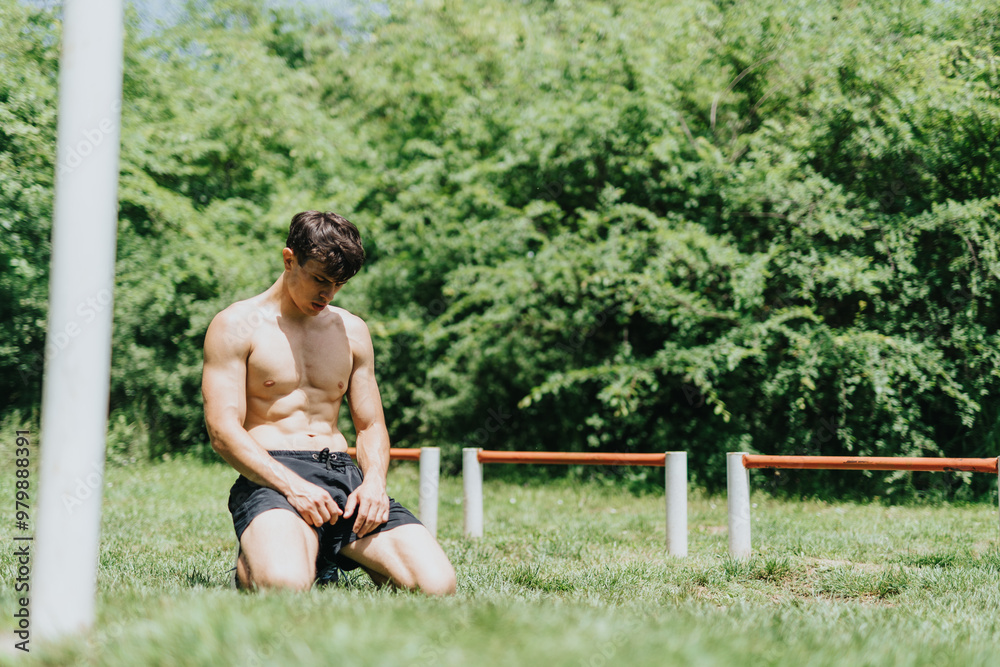Fit man exercising in nature, showcasing athletic build and abs through ...