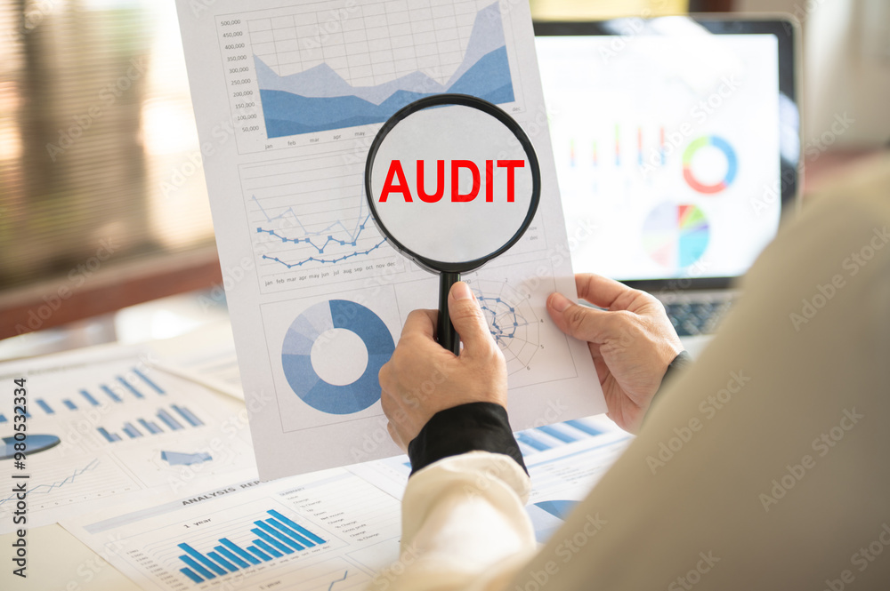 Magnifying glass with audit word. Auditing the reliability of financial ...