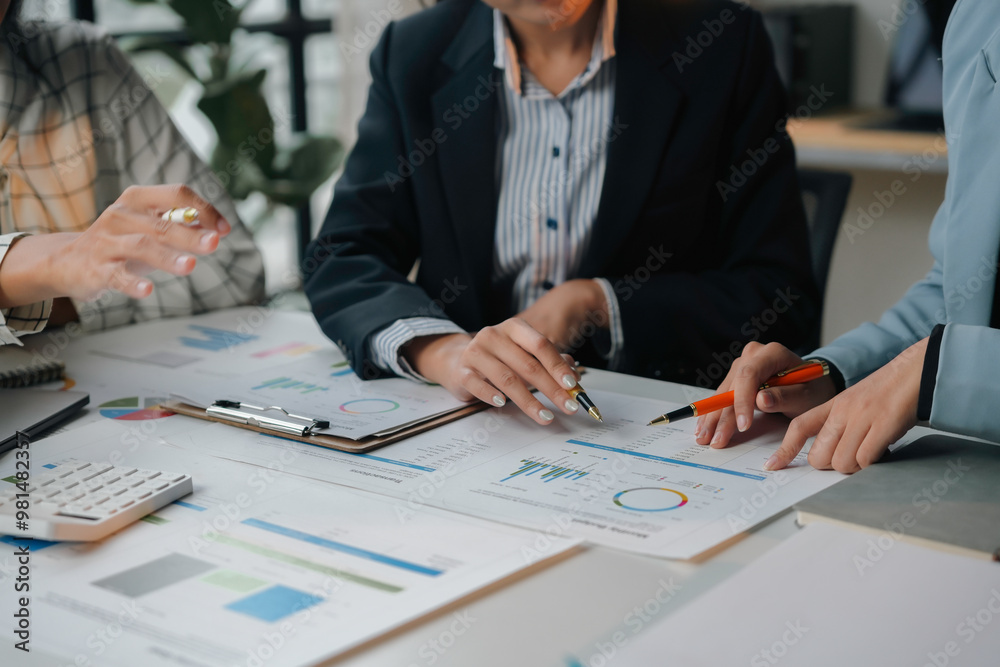 Collaborative business team analyzing financial data with charts and ...