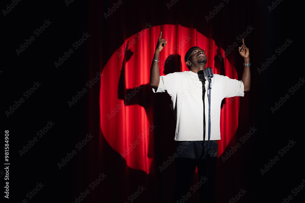 Concert of professional pop singer. African american man sings song ...