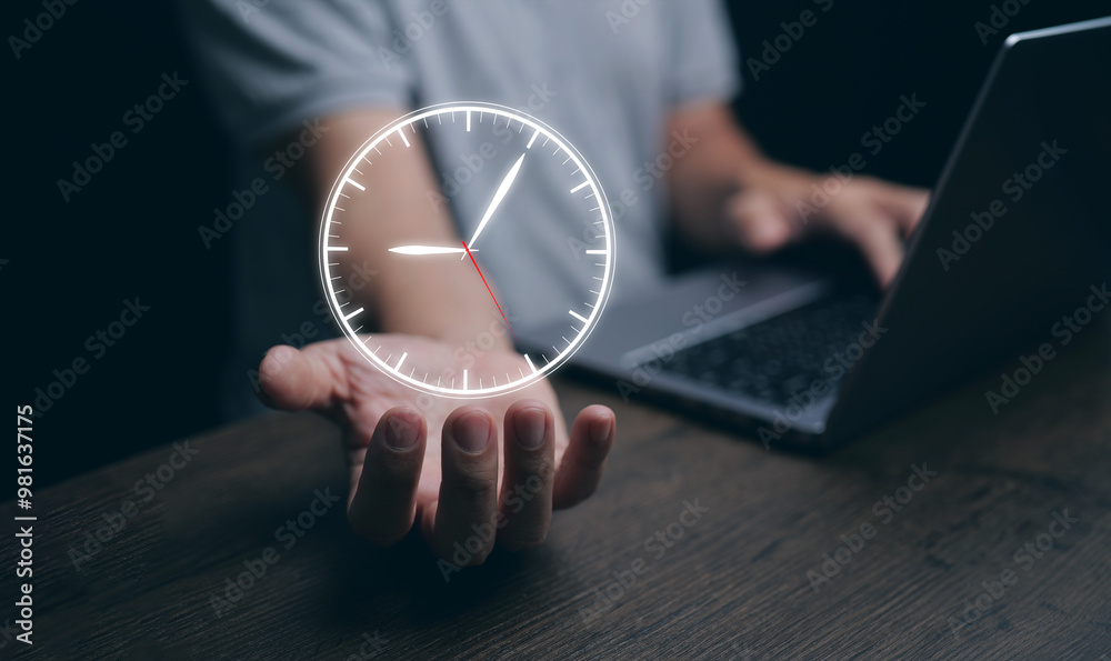 Time management concept, Working man with clock in his hand paying ...