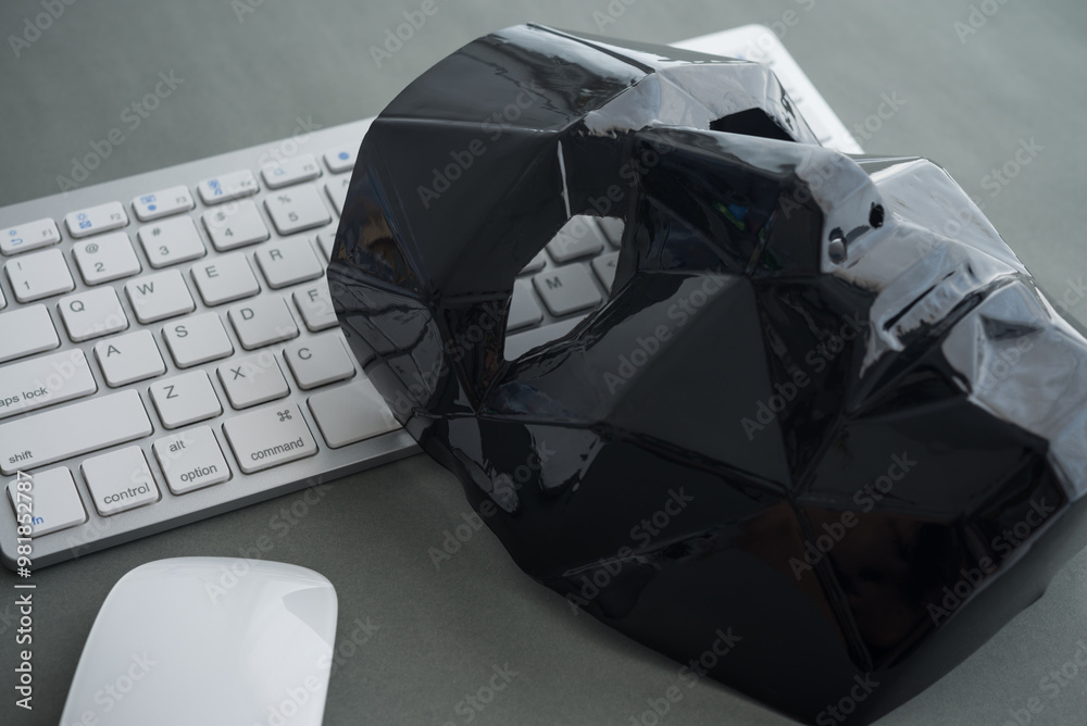 Black scary half face mask, keyboard and mouse on gray table background ...