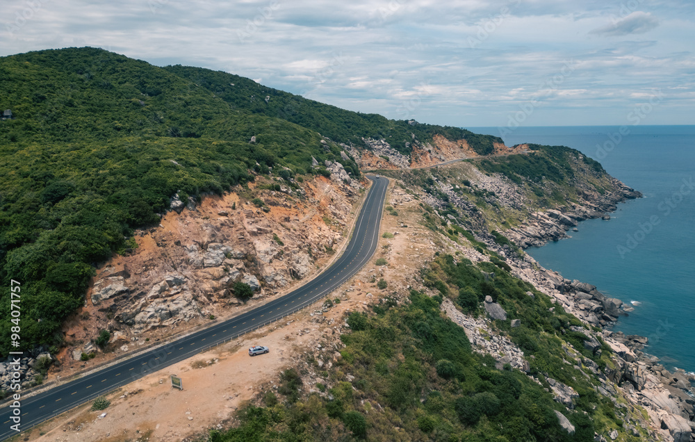 Aerial view of SUV car arriving on beach with beautiful sea view ...