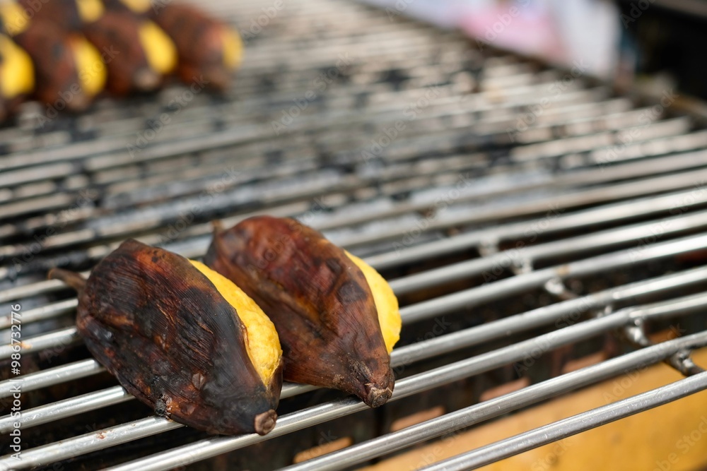 Grilled kluay khai (ladyfinger bananas) still in their skins for sale ...