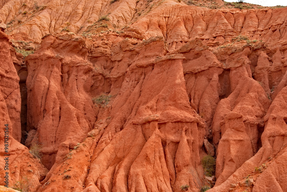 Northern Kyrgyzstan. The unusual texture of red-yellow clay rocks in ...