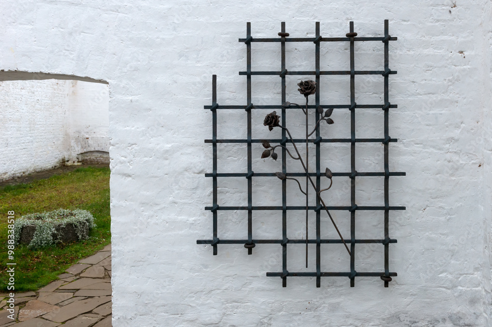 Forged roses behind prison bars. The monastery prison. The Spaso ...