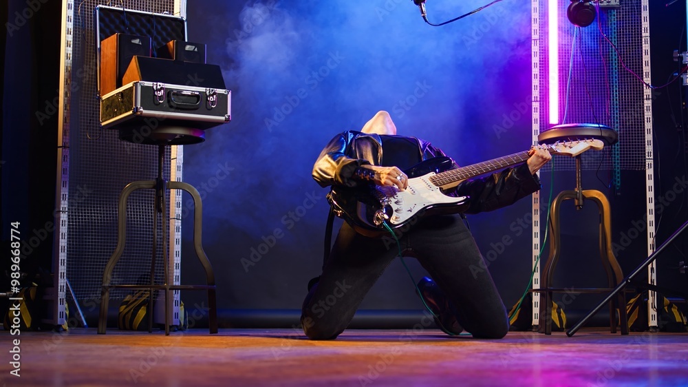 Foto de Stock Confident female rocker performing live with a bass ...