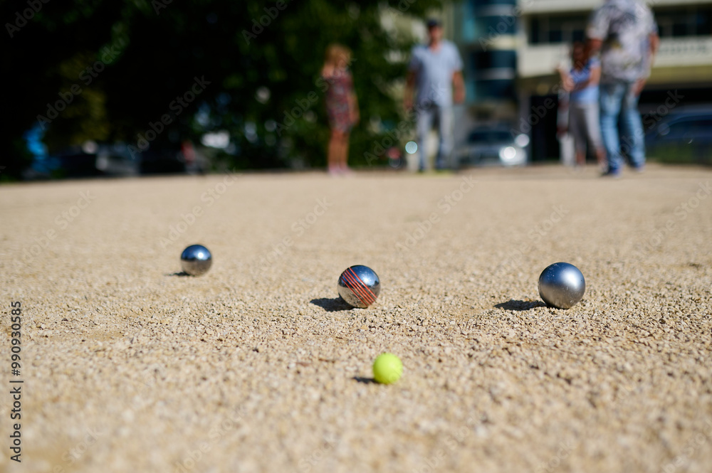 Close-up of petanque balls scattered on gravel with the target ball in ...