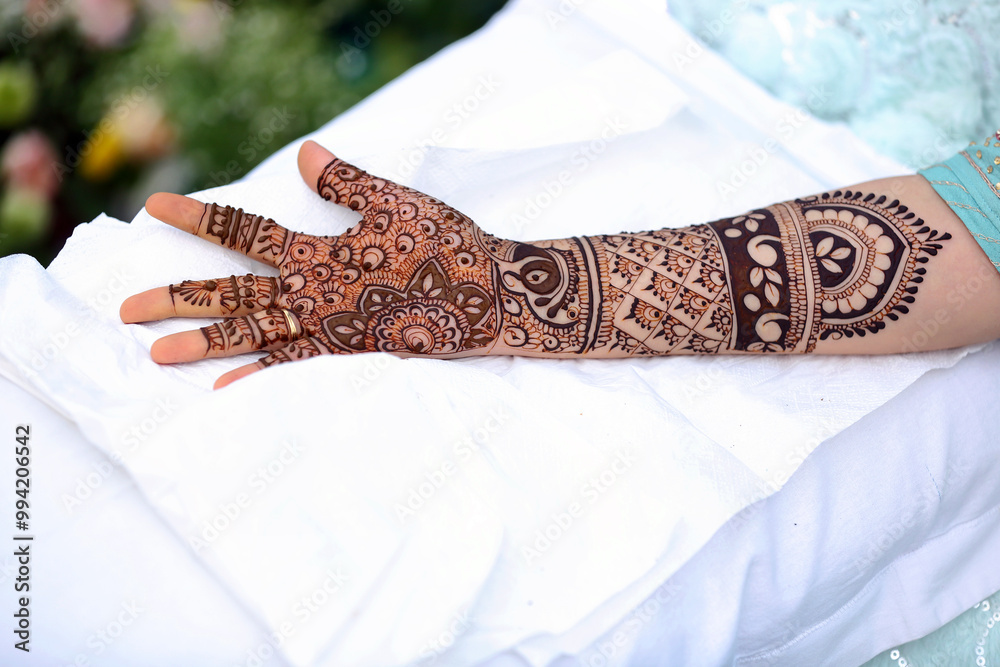 Exquisite mehndi designs embellish the bride's hands and arms, with the ...