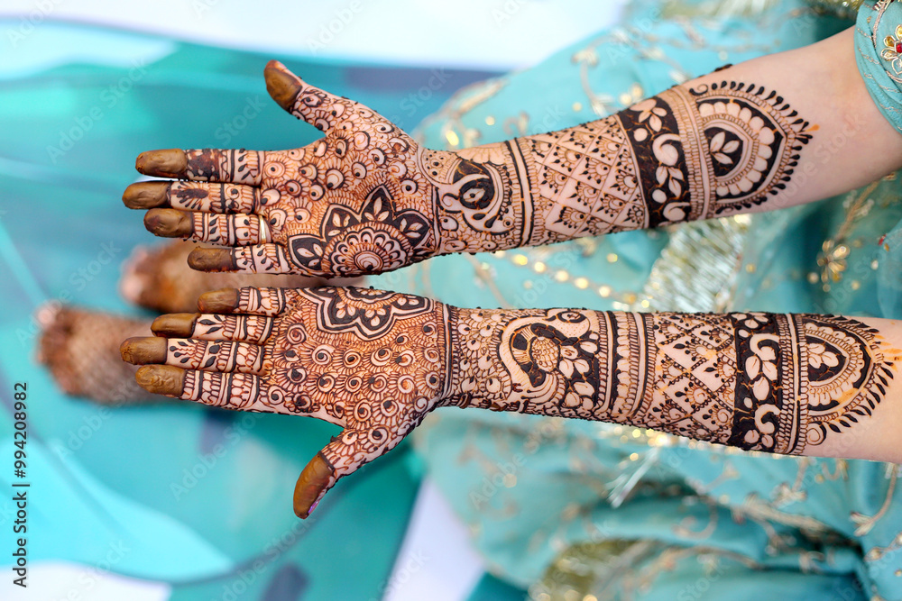 Exquisite mehndi designs embellish the bride's hands and arms, with the ...