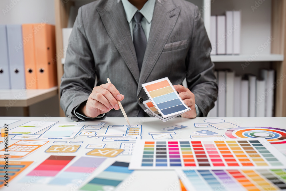 System Developer Analyzing UX UI Plans with Color Swatches and Design ...
